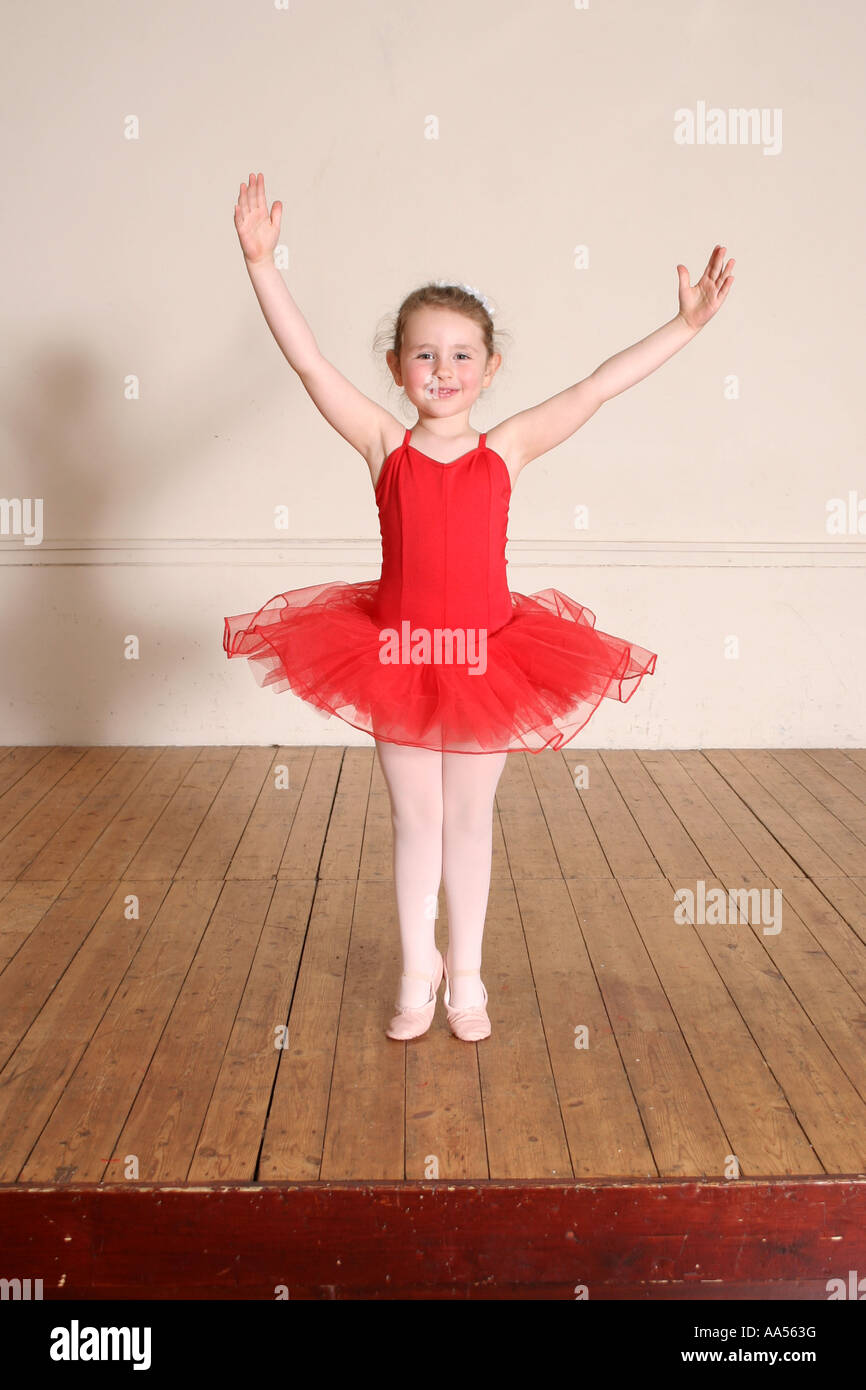 A young ballerina dressed in a red tutu, dancing on stage Stock Photo ...