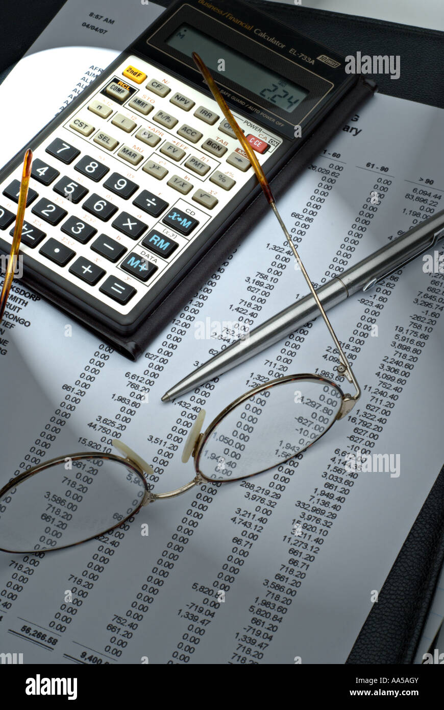 Financial statement with calculator and silver pen Stock Photo - Alamy