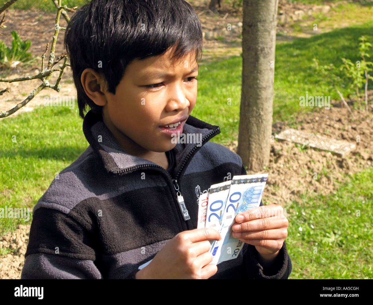 boy with money gift Stock Photo - Alamy
