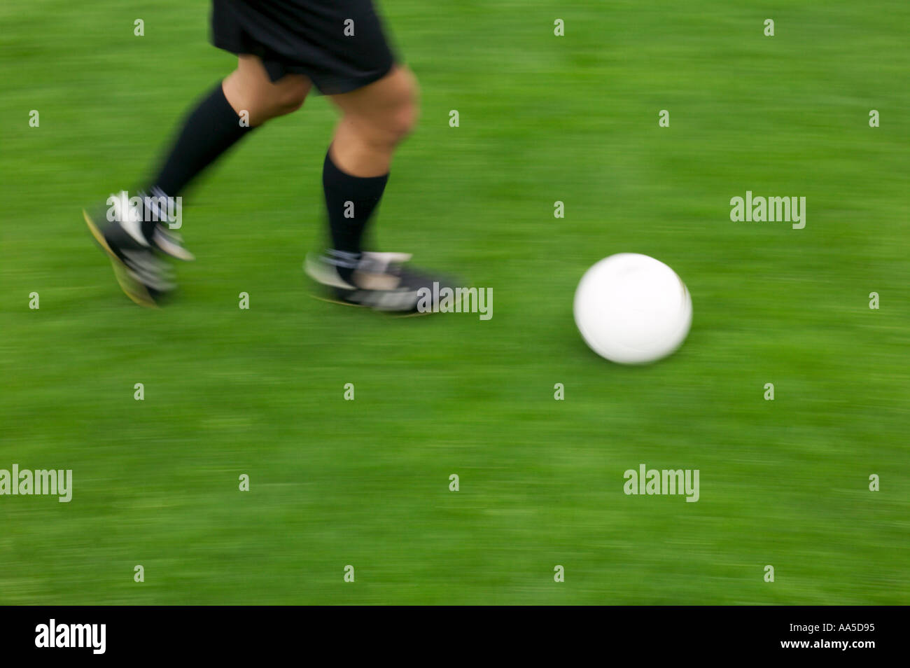 legs of soccer player running after ball Stock Photo - Alamy
