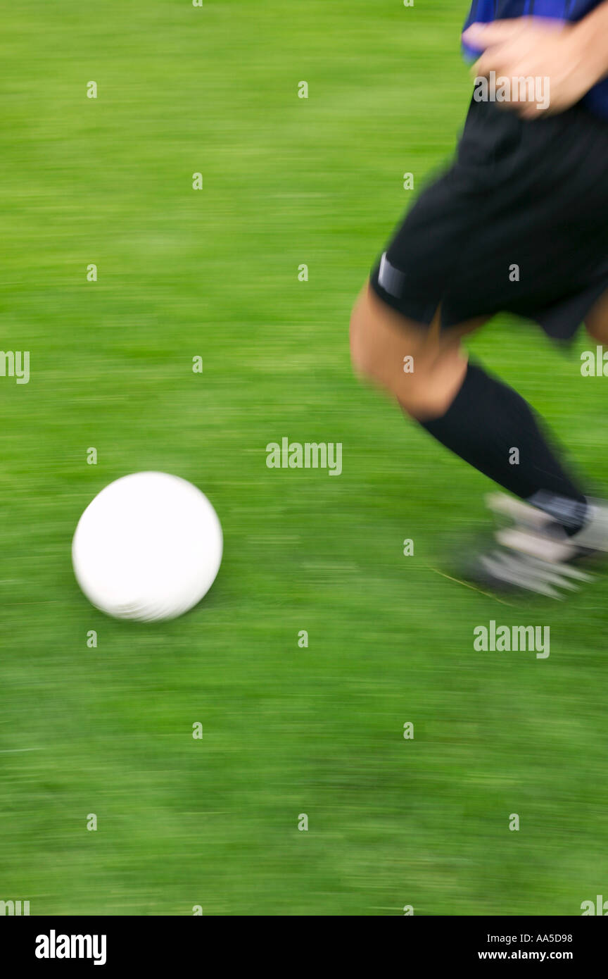 legs of soccer player running after ball Stock Photo - Alamy
