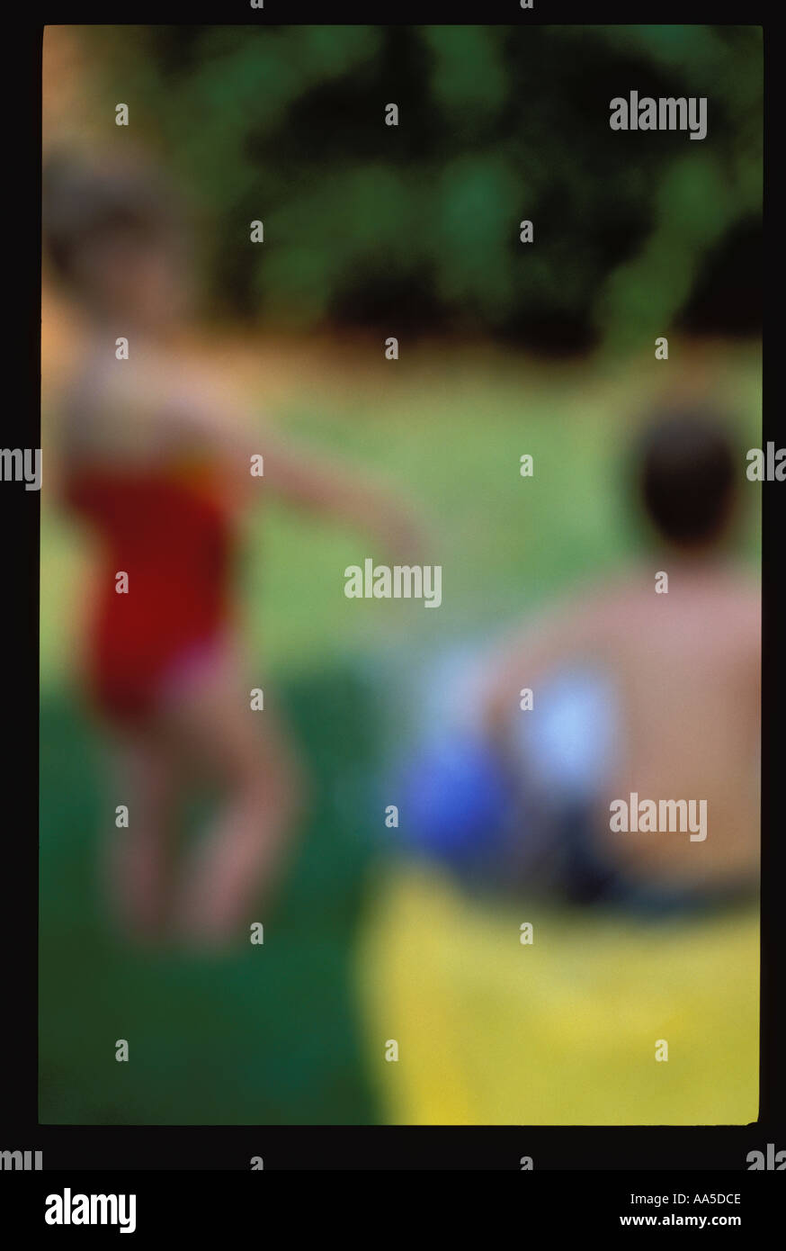 Playing together on a silp n slide, soft focus Stock Photo - Alamy