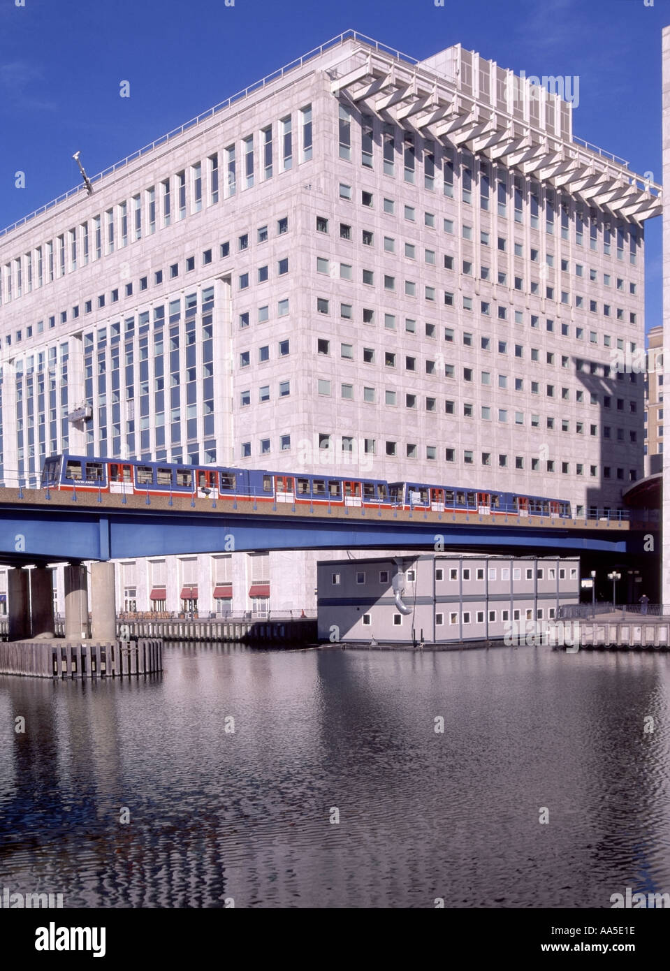 London Docklands light railway above dock waters between Canary Wharf ...
