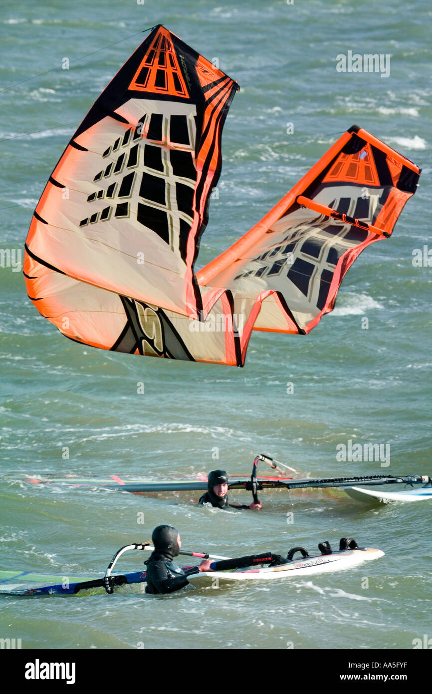 Kite board sail with two windsurfers in water Stock Photo - Alamy