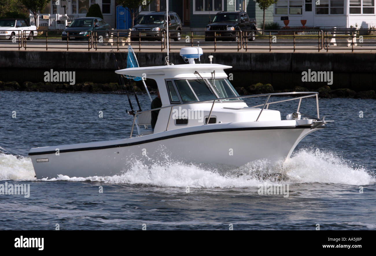 A private fishing boat headed down the Manasquan Inlet Stock Photo - Alamy