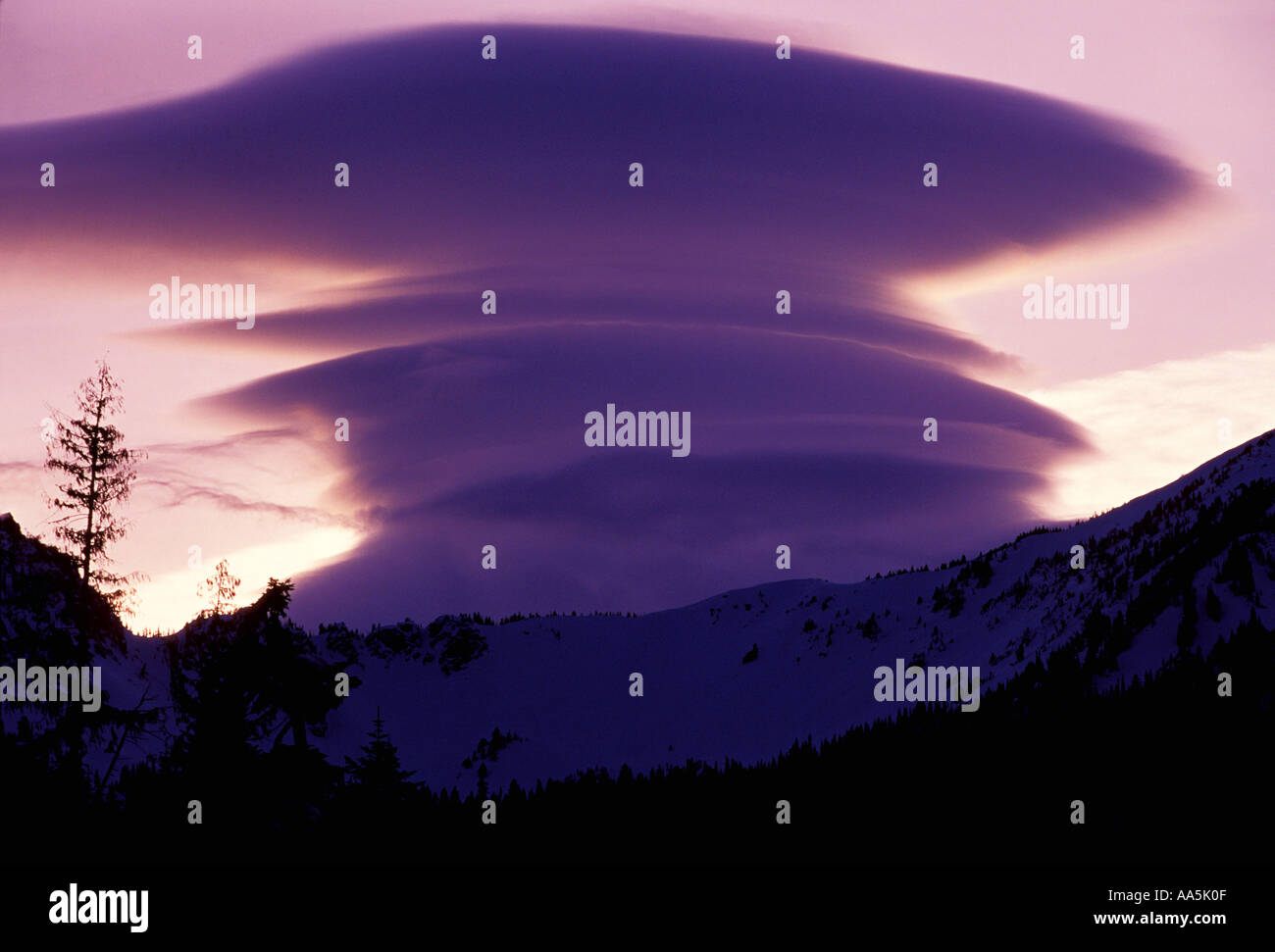 A stack of lenticular clouds indicate a coming storm over the Cascade ...
