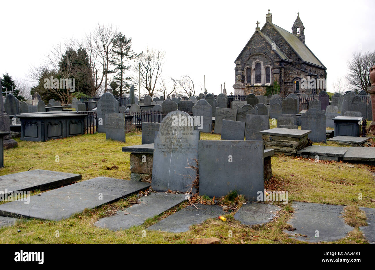 Church and graveyard with slate gravestones at Llan Ffestiniog Gwynedd ...
