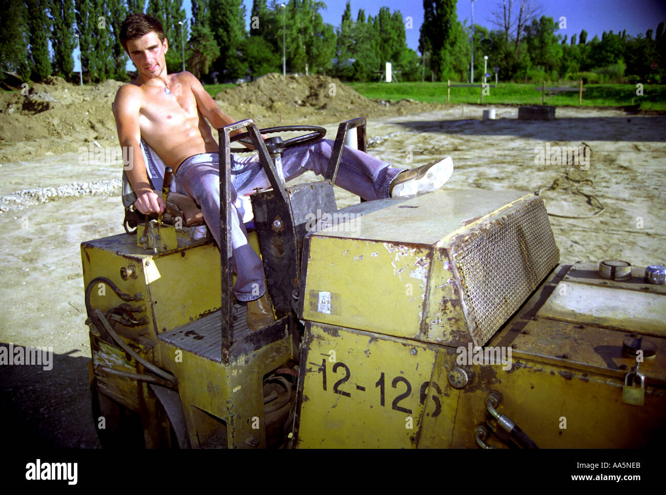 the young men is is posing on machine Stock Photo - Alamy