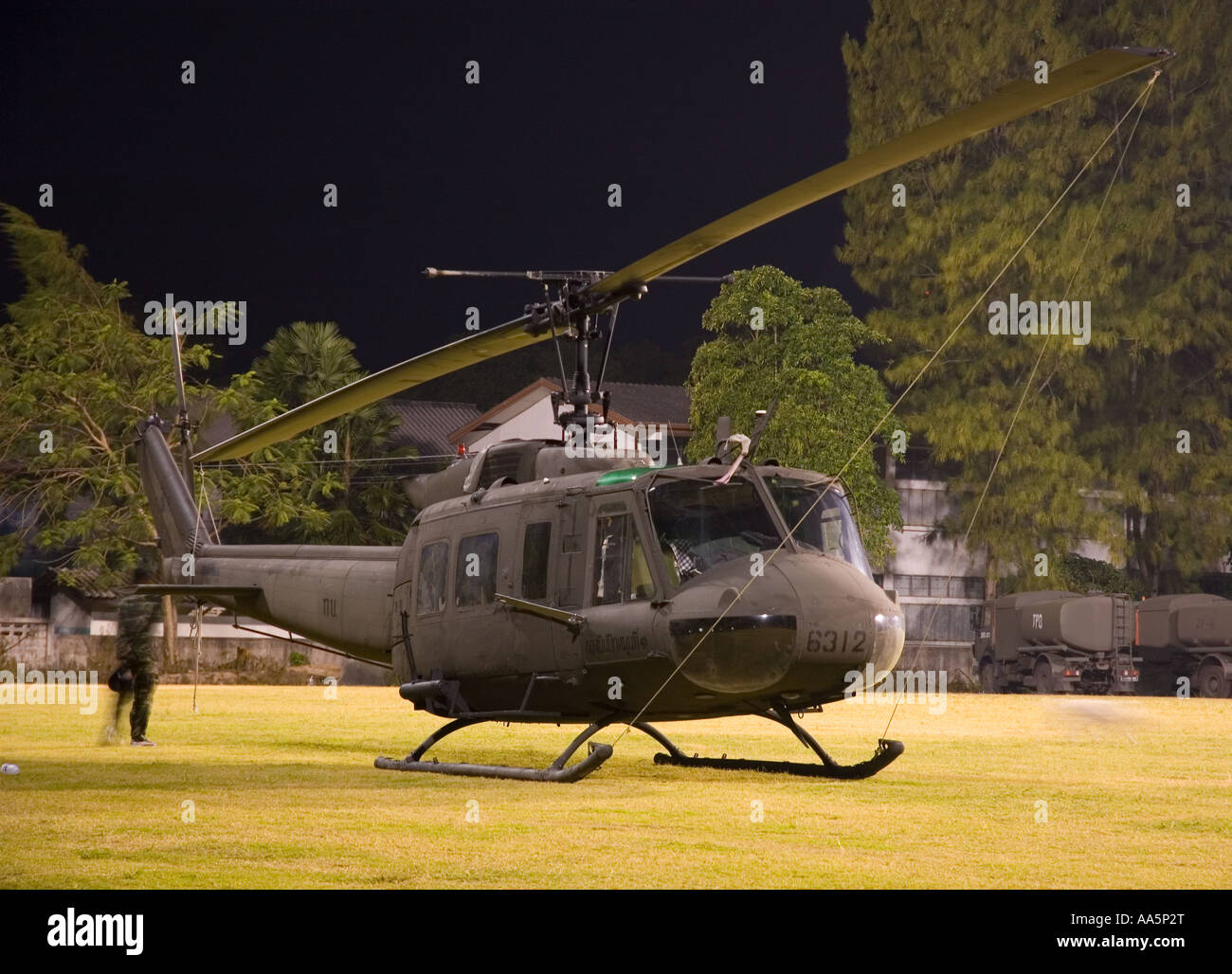 Military Helicopter stationary on a landing pad on a sports field in ...