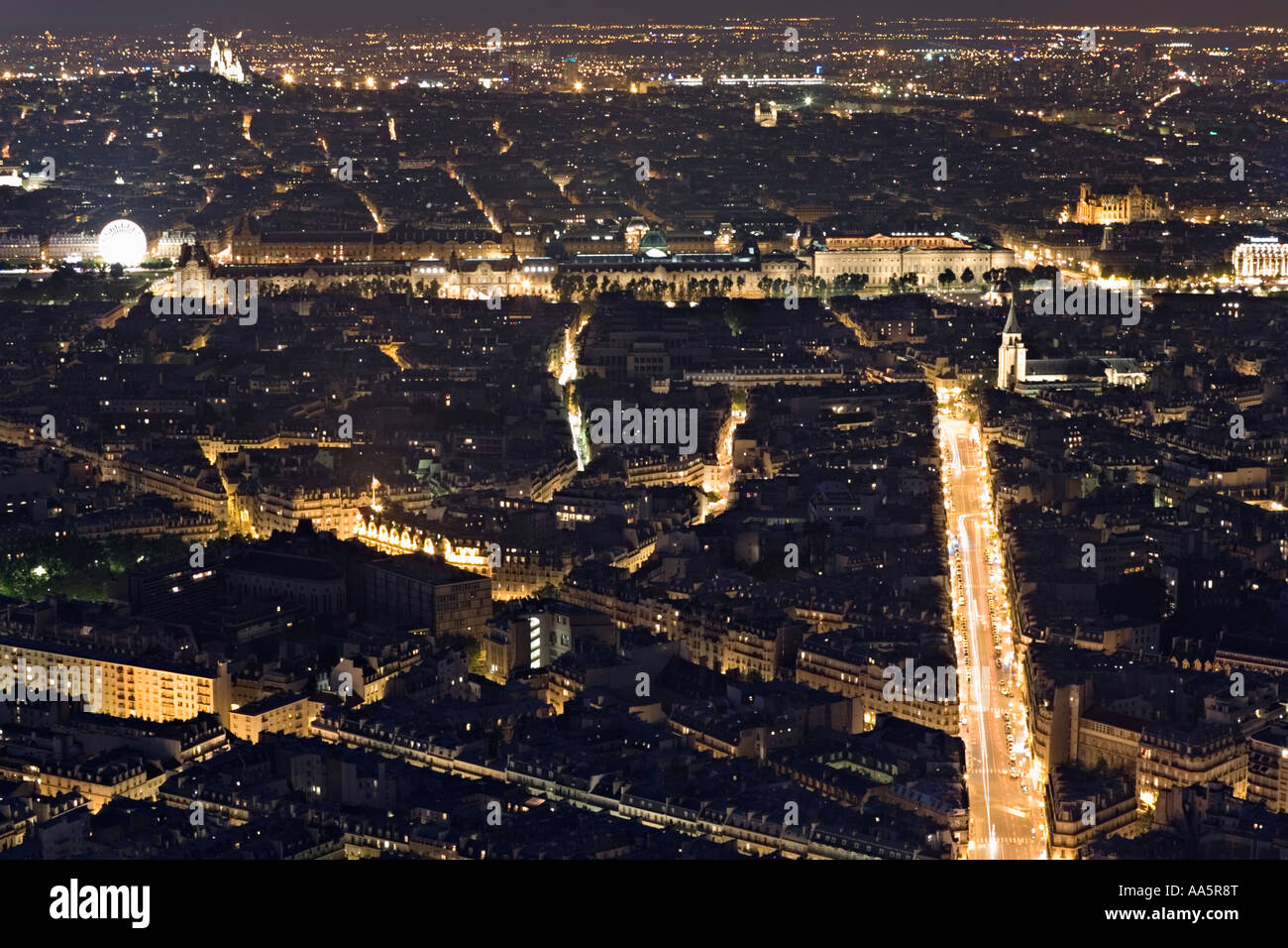 FRANCE PARIS Cityscape at night. Aerial View. Main road leads to Louvre ...