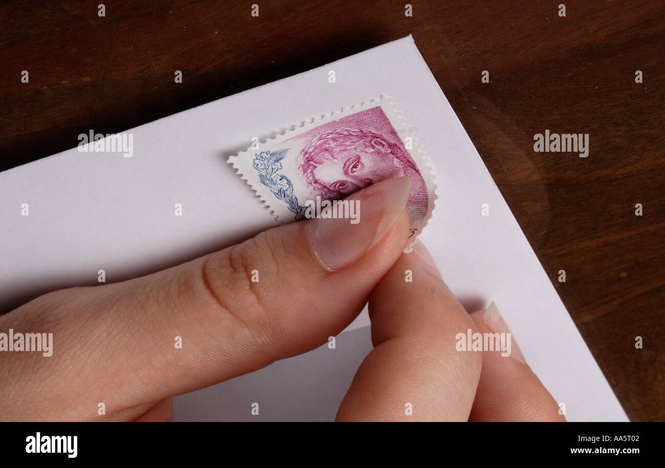 woman hands stick glue stamp envelope thimble send Stock Photo - Alamy