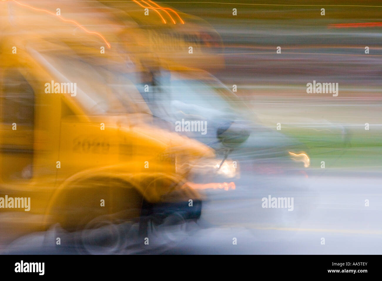 Panning shot of a yellow school bus speeding by Stock Photo - Alamy