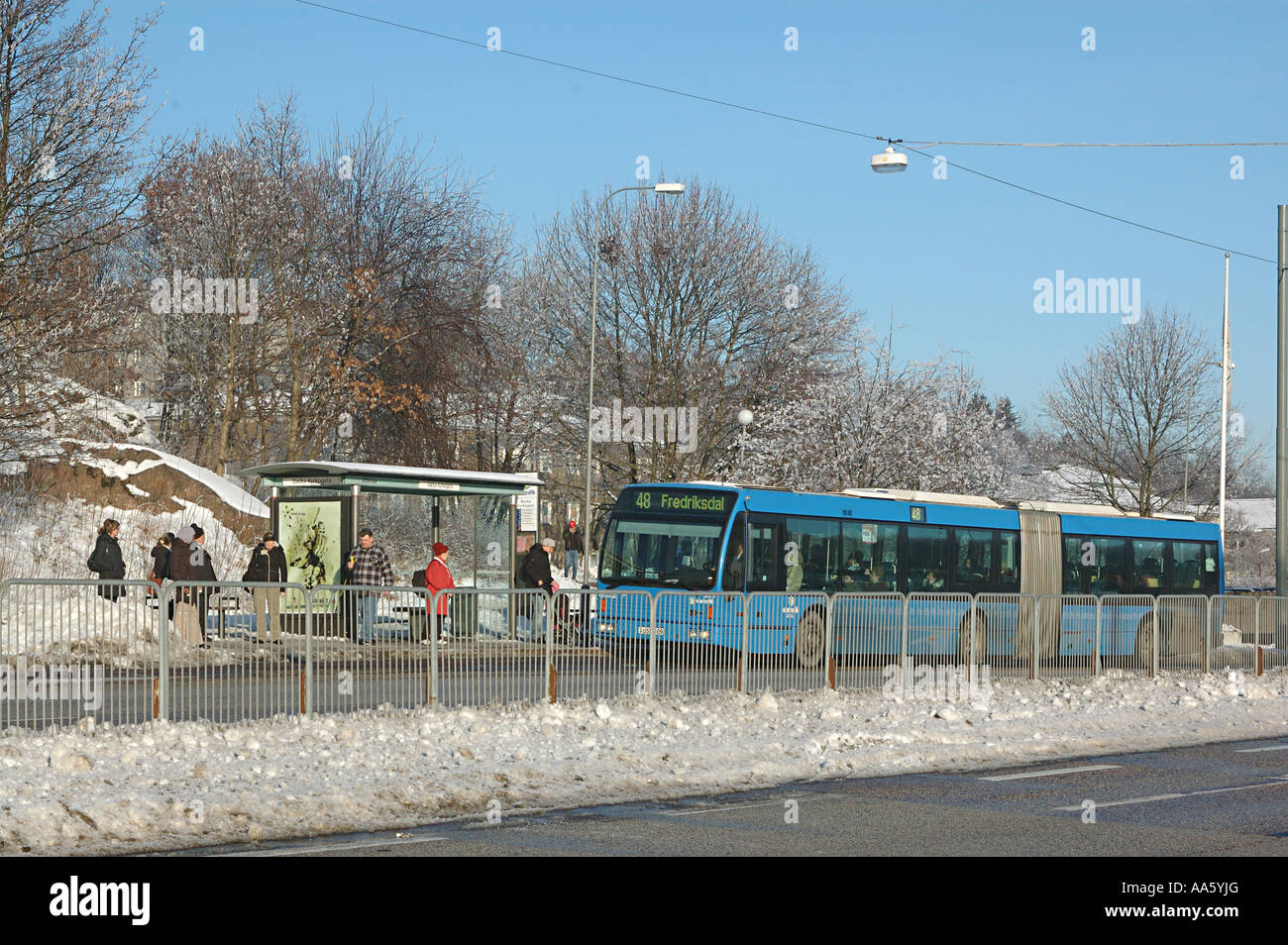 Bus at glass bus stop, road divider fence, Backa Kyrkogata, Gothanborg ...