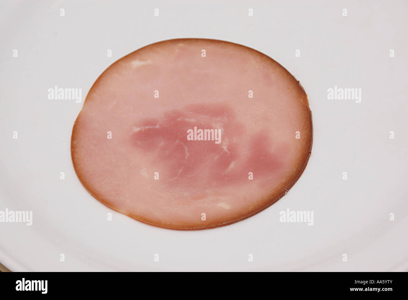 Smoked ham slice in the plate Stock Photo - Alamy