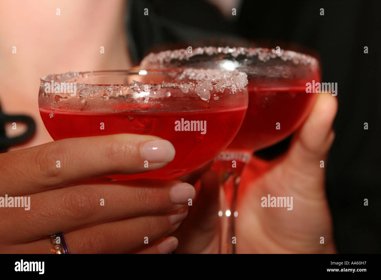 Cheers - drinking cocktails Stock Photo - Alamy