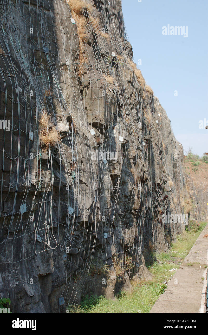 Net of steel wire nailed in rocks to hold landslide loose rocks of the ...