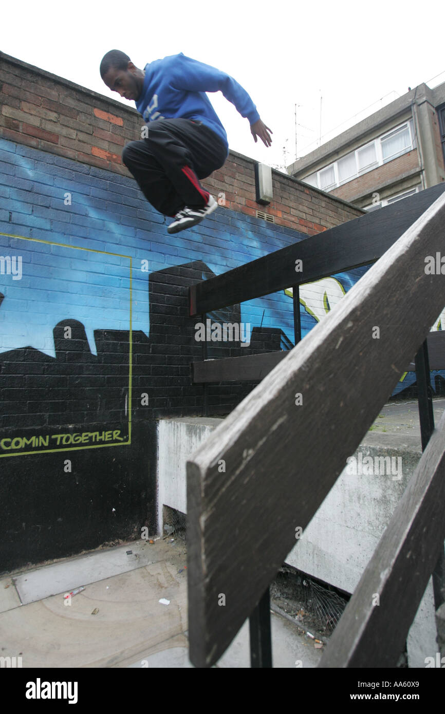 A parkour freerunning athlete vaulting jumping over a rail Stock Photo ...