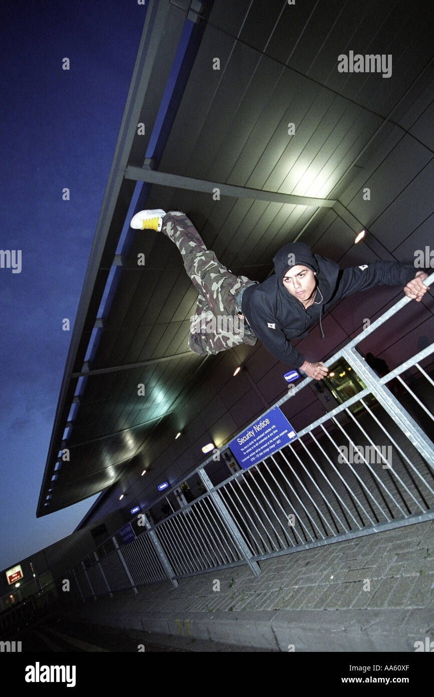 A parkour freerunning athlete vaulting over a rail Stock Photo - Alamy