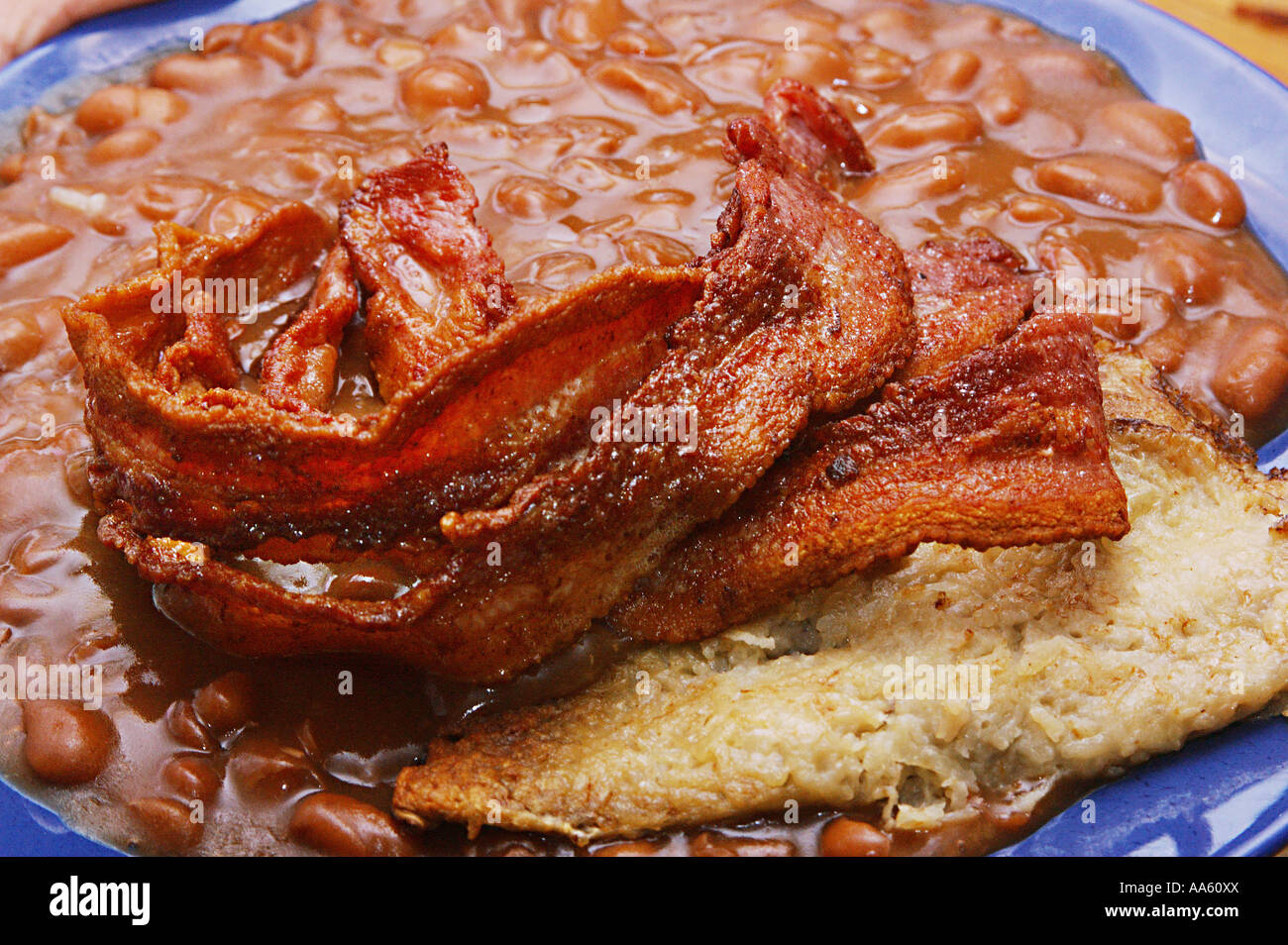 Swedish fried Bacon Strips with brown beans and potato pancake Stock ...