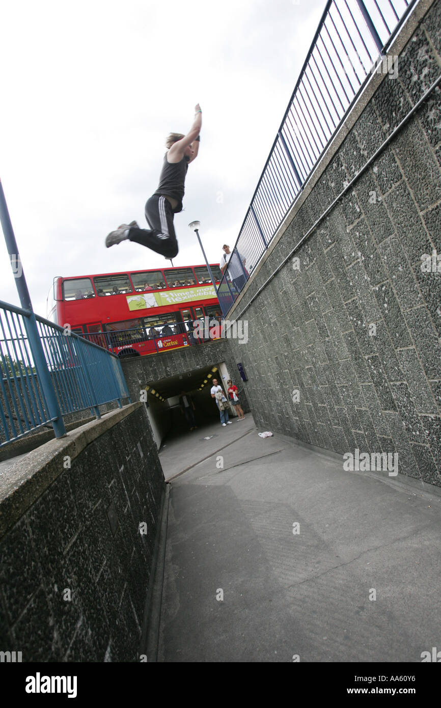 A man doing parkour, performing a cat leap (arm jump, saut de bras) at ...