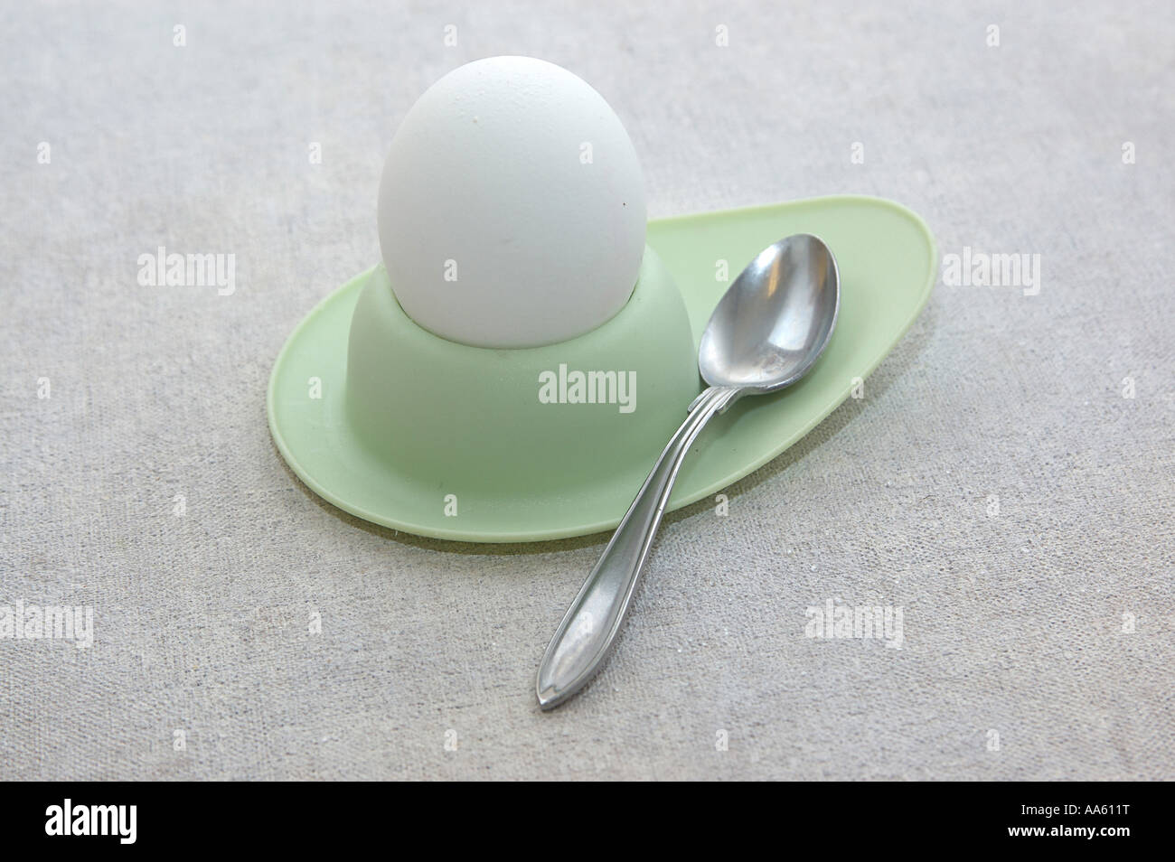 Boiled egg in egg holder cup and spoon Stock Photo - Alamy
