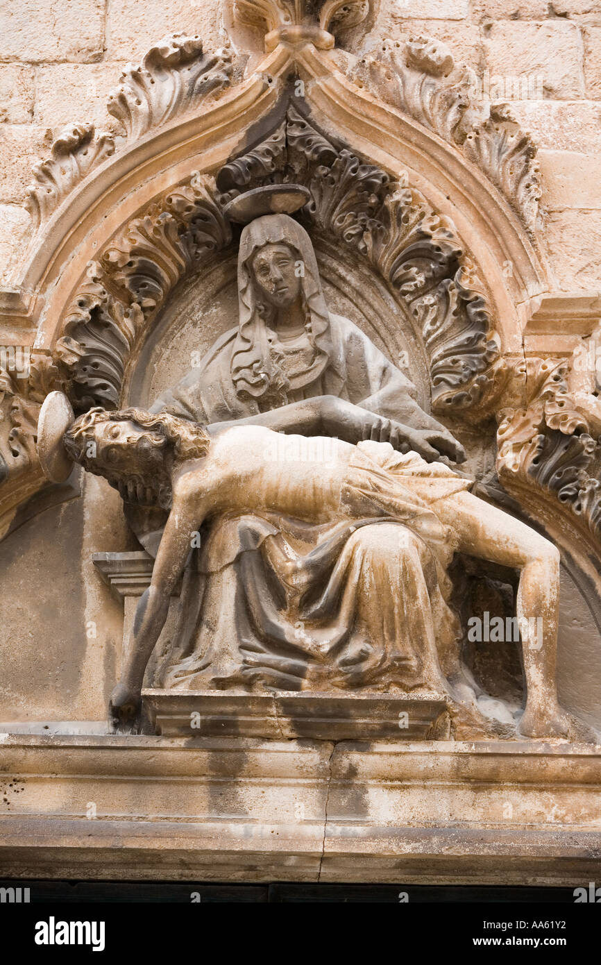 Statue of Virgen Mary Holding dead Body of Jesus on the entrance of a ...