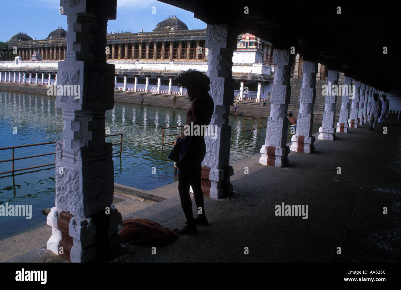 A Sadhu, or Hindu holy man, prepares to bathe in a pool in a temple in ...