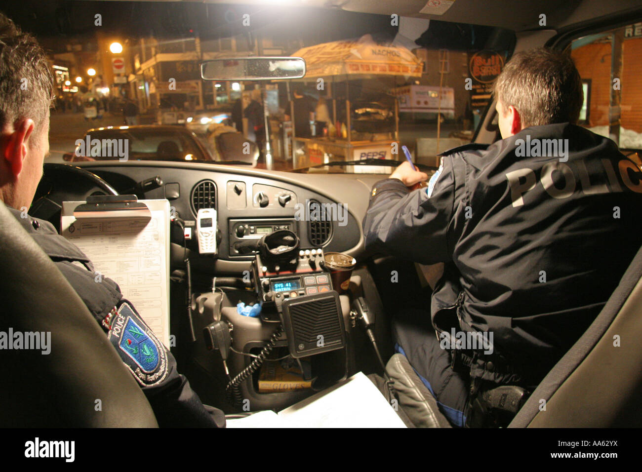 Royal Newfoundland Constabulary officers writing a report in their ...