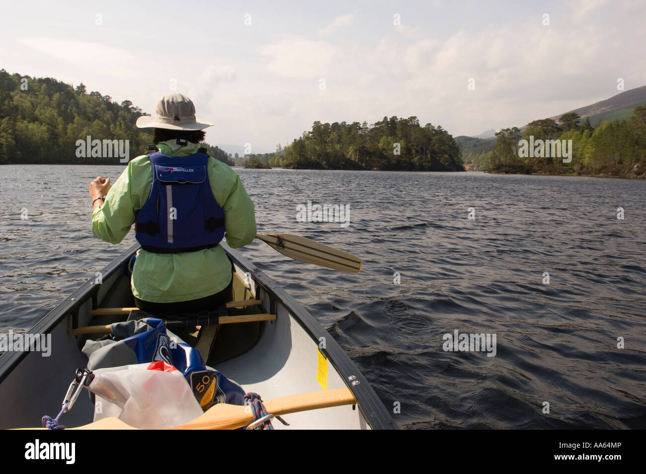 A female canoeist on a Loch in Glen Affric Scotland Stock Photo - Alamy