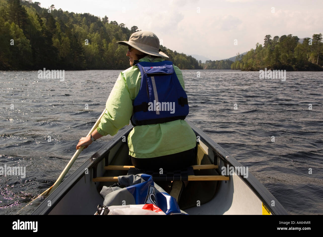 A female canoeist on a Loch in Glen Affric Scotland Stock Photo - Alamy