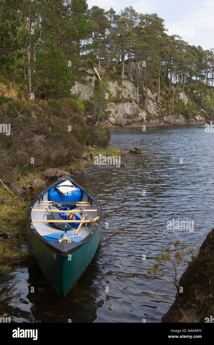 A canoe tied up on an island on a loch in Glen Affric Scotland Stock ...