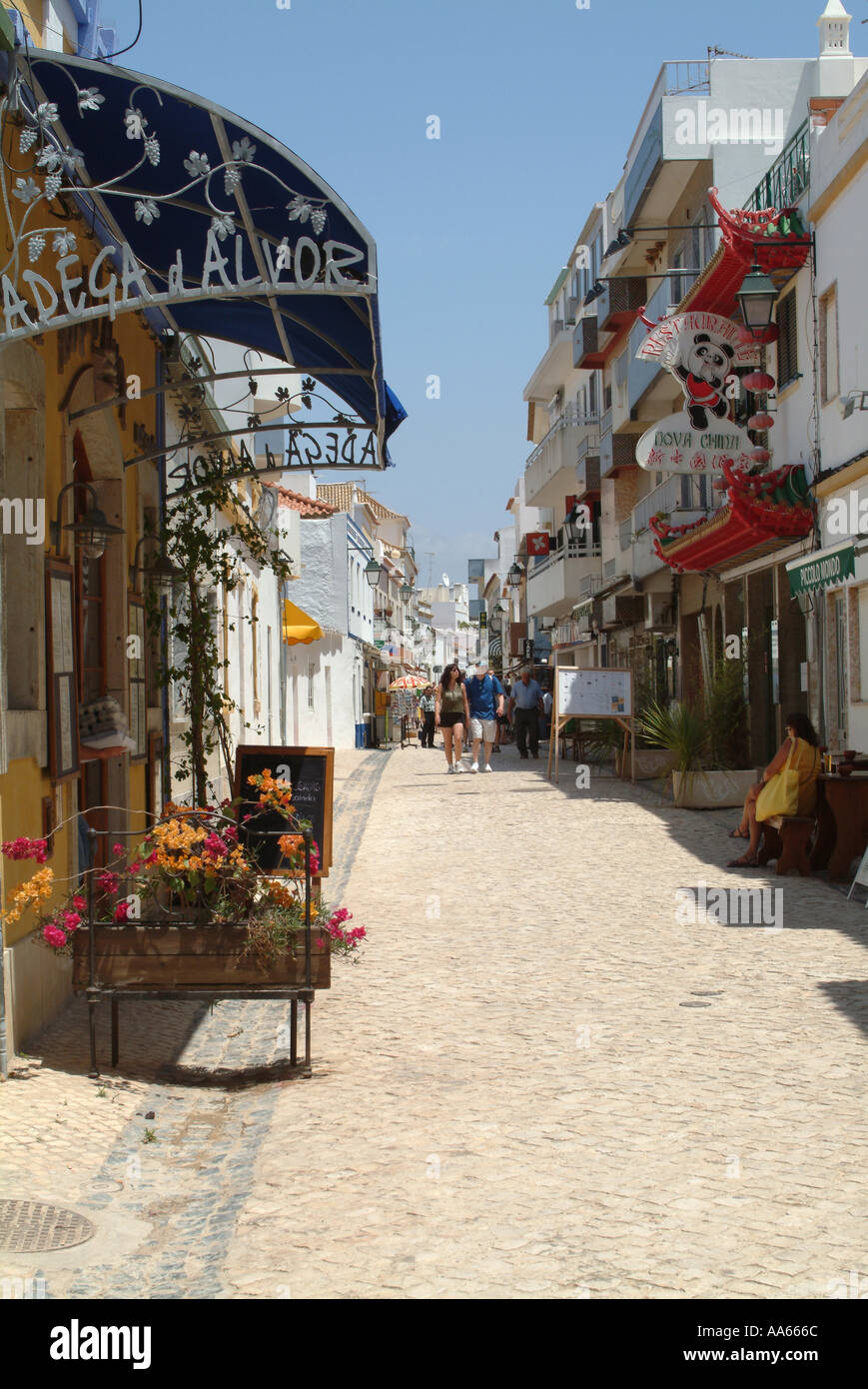 Restaurant Shops and People Sightseeing in Cobbled Street at Alvor Town ...