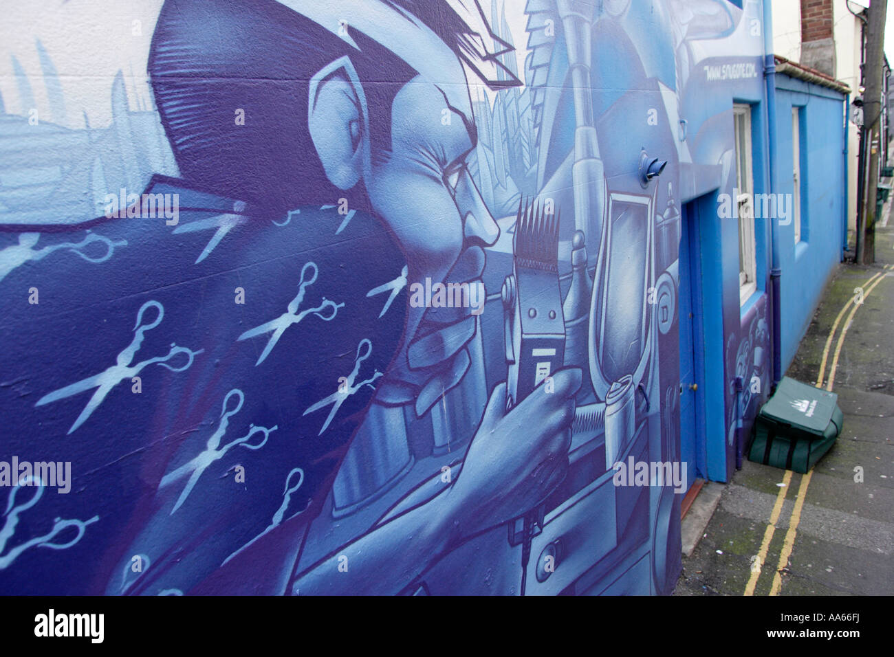 Graffiti mural of a crazy barber painted on the front of a ...