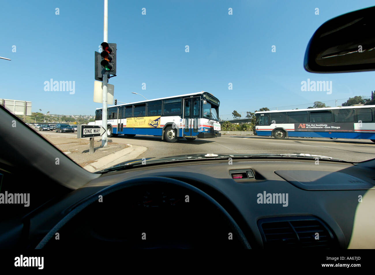 Busy intersection with two buses viewed from inside a car San Diego ...