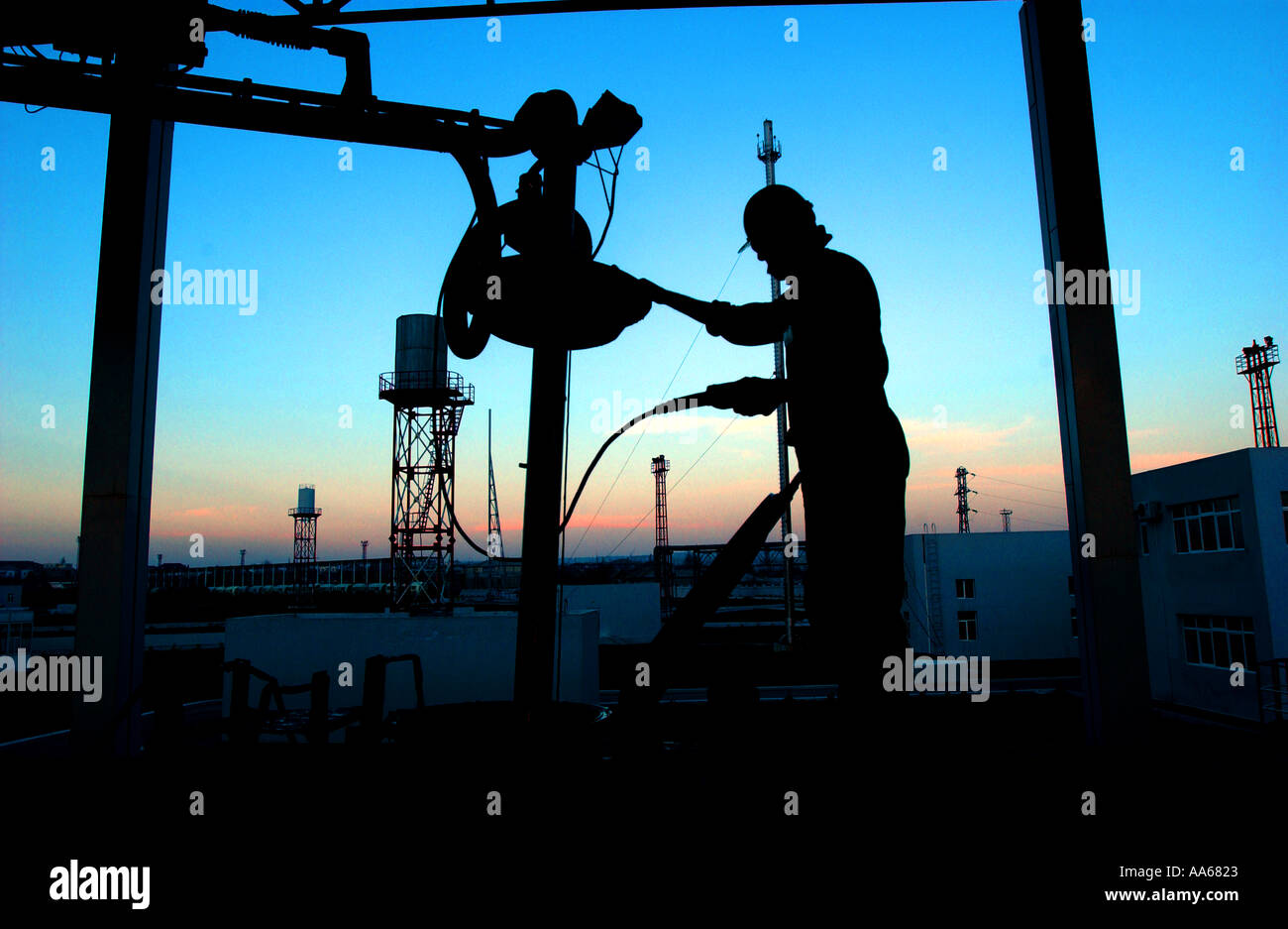 An oil worker unloads a tanker full of oil at Azpetrol on the Caspian ...