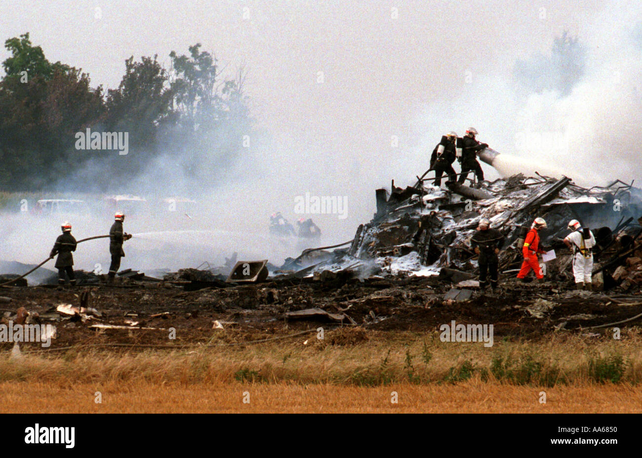 Firefighters put out the last flames of the Air France Concorde that ...