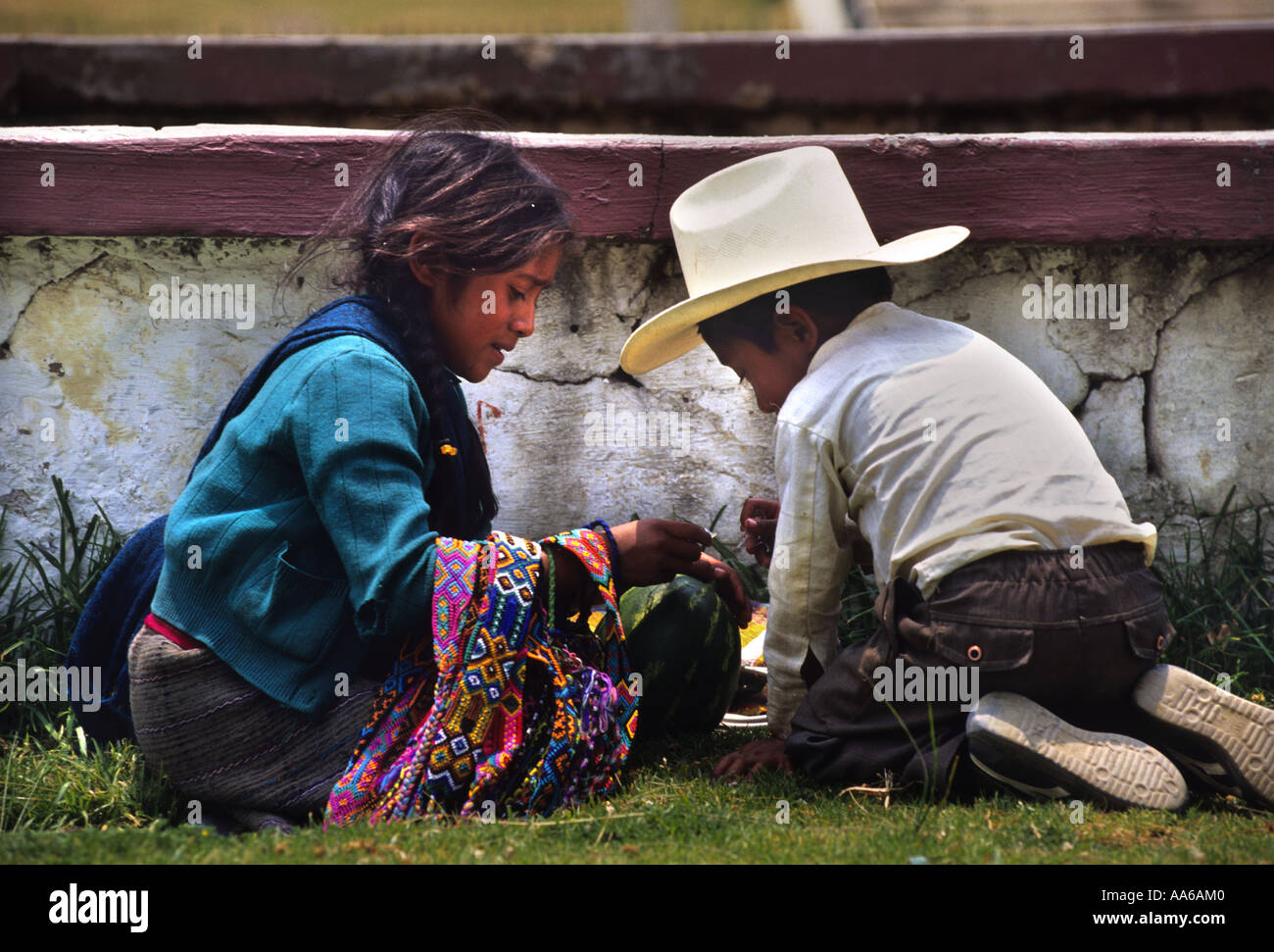 A CHAMULAN MAYAN INDIAN GIRL WITH A BOY AT A MARKET IN SAN JUAN CHAMULA ...