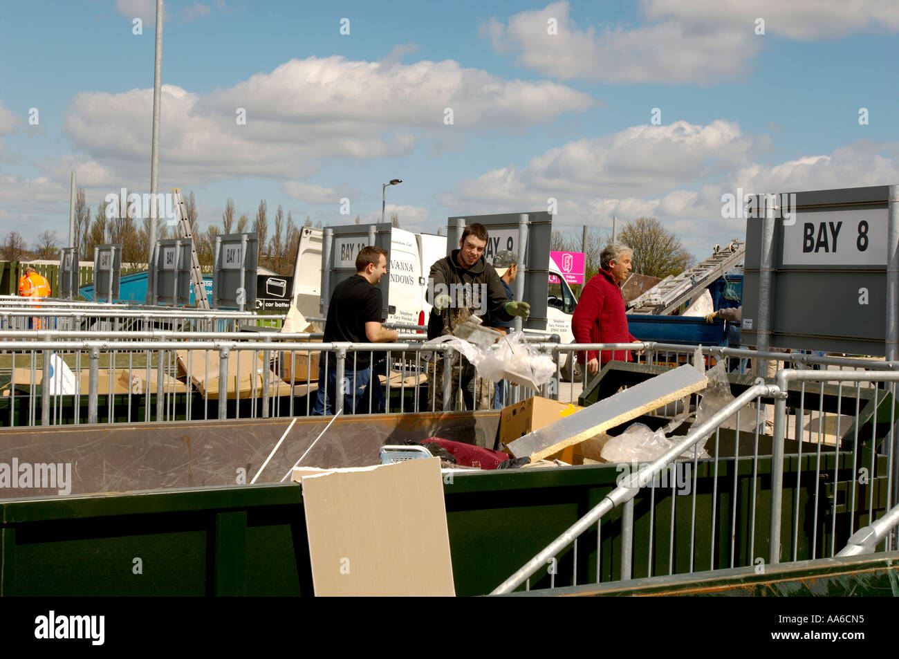 Man disposing of rubbish into a skip at a waste management centre in ...