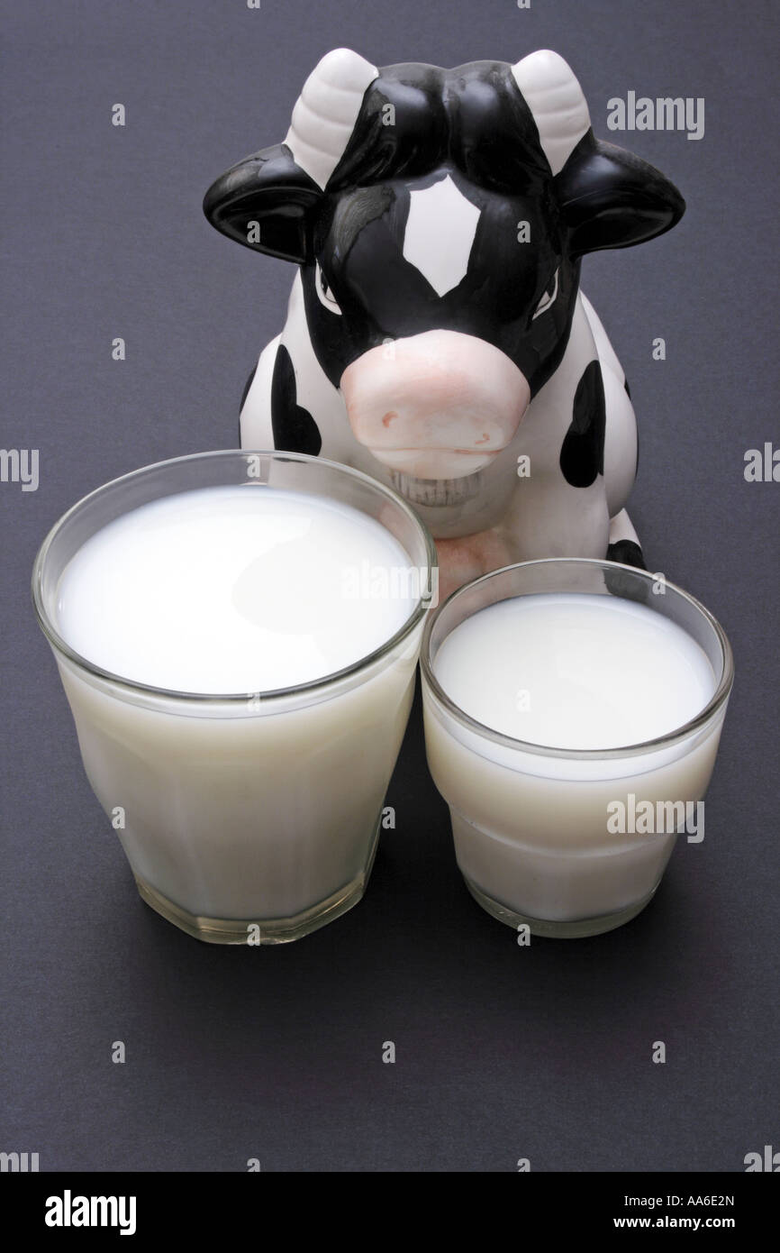 A cow and its milk ready to drink Stock Photo - Alamy