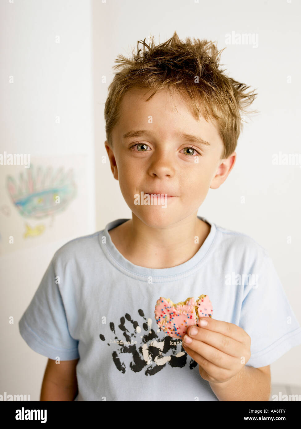 young boy 7 eating a biscuit Stock Photo - Alamy