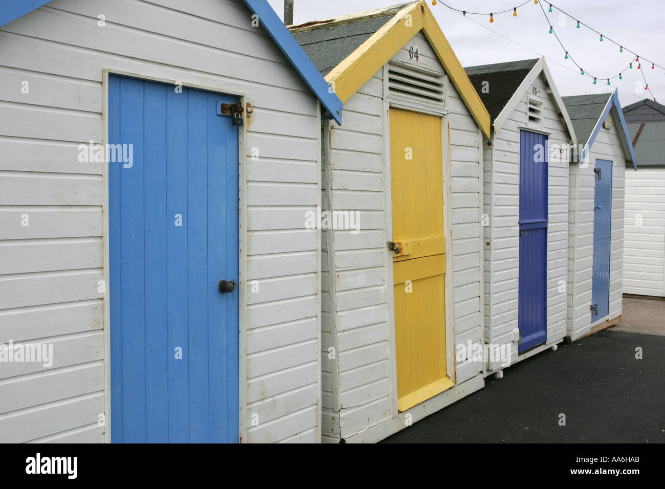 Victorian beach huts with brightly painted doors stand on Paignton ...
