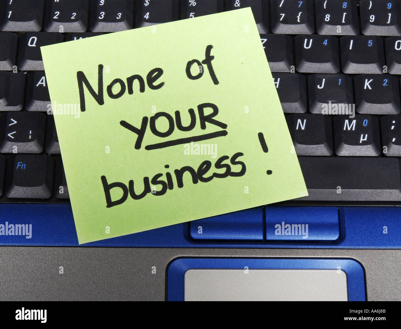 memo note on notebook, none of your business Stock Photo - Alamy