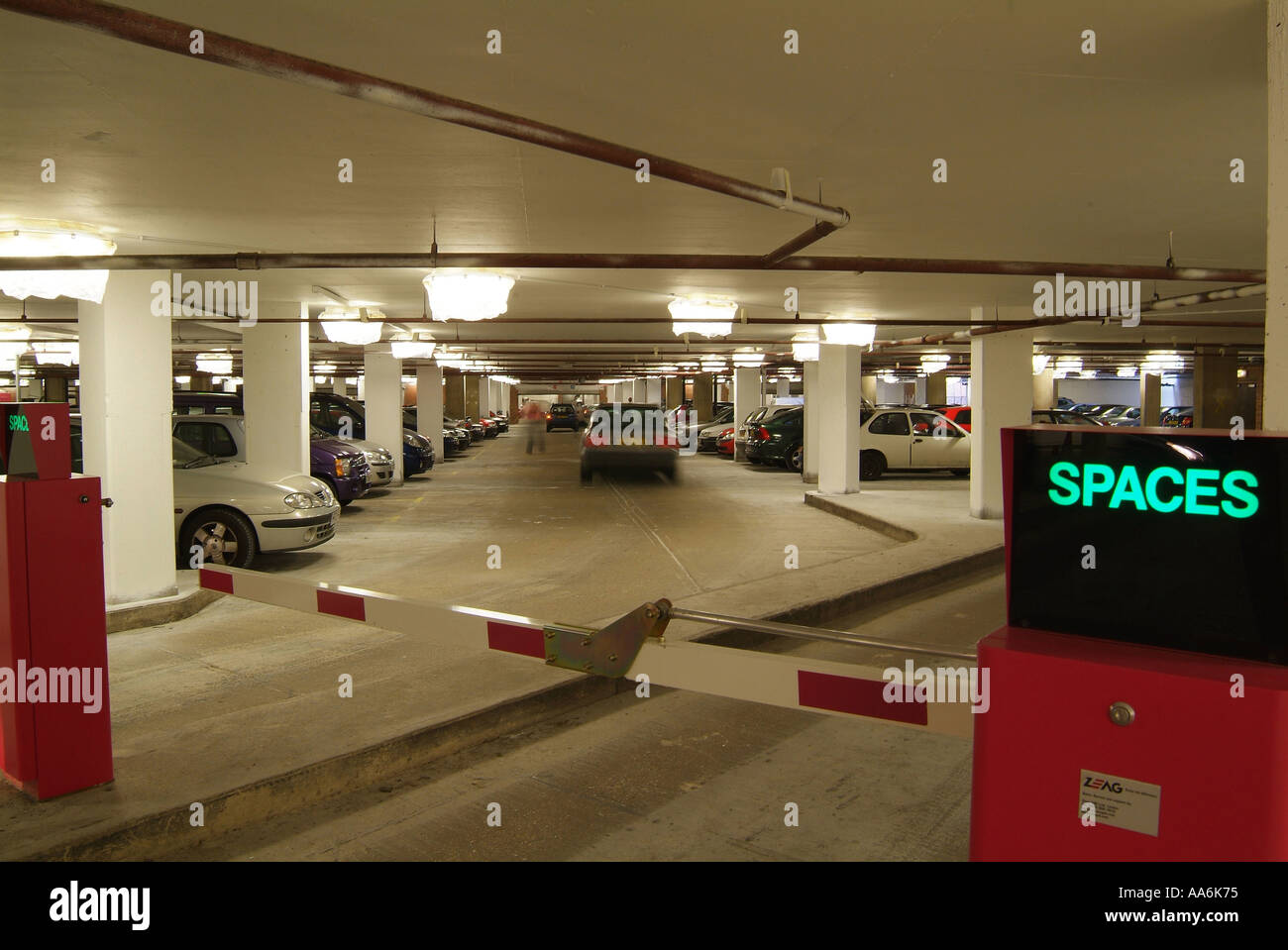 An underground suburban car park with a spaces sign by the automatic ...