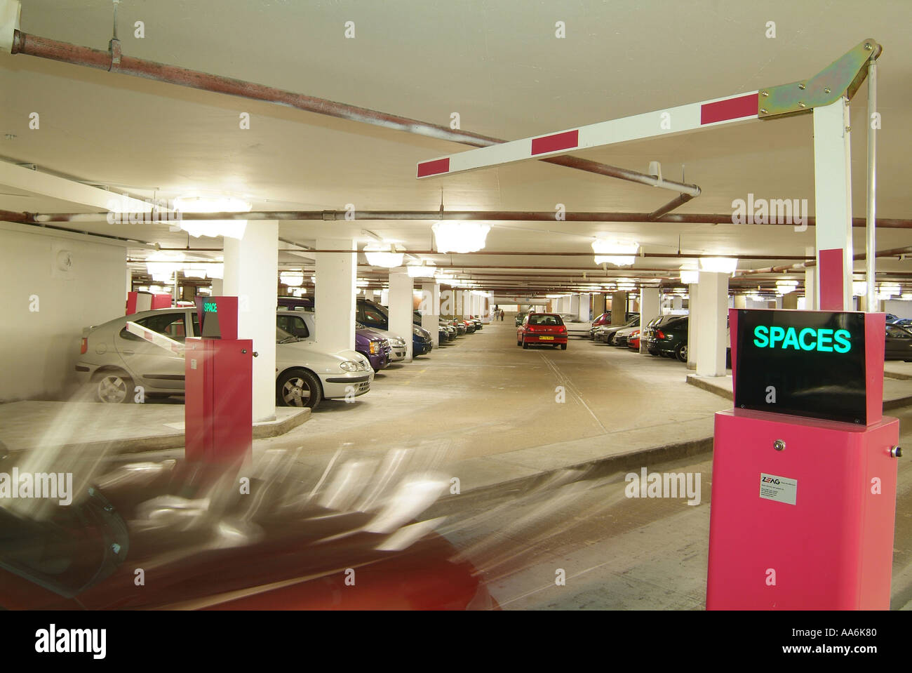 An underground suburban car park with a spaces sign by a raised ...