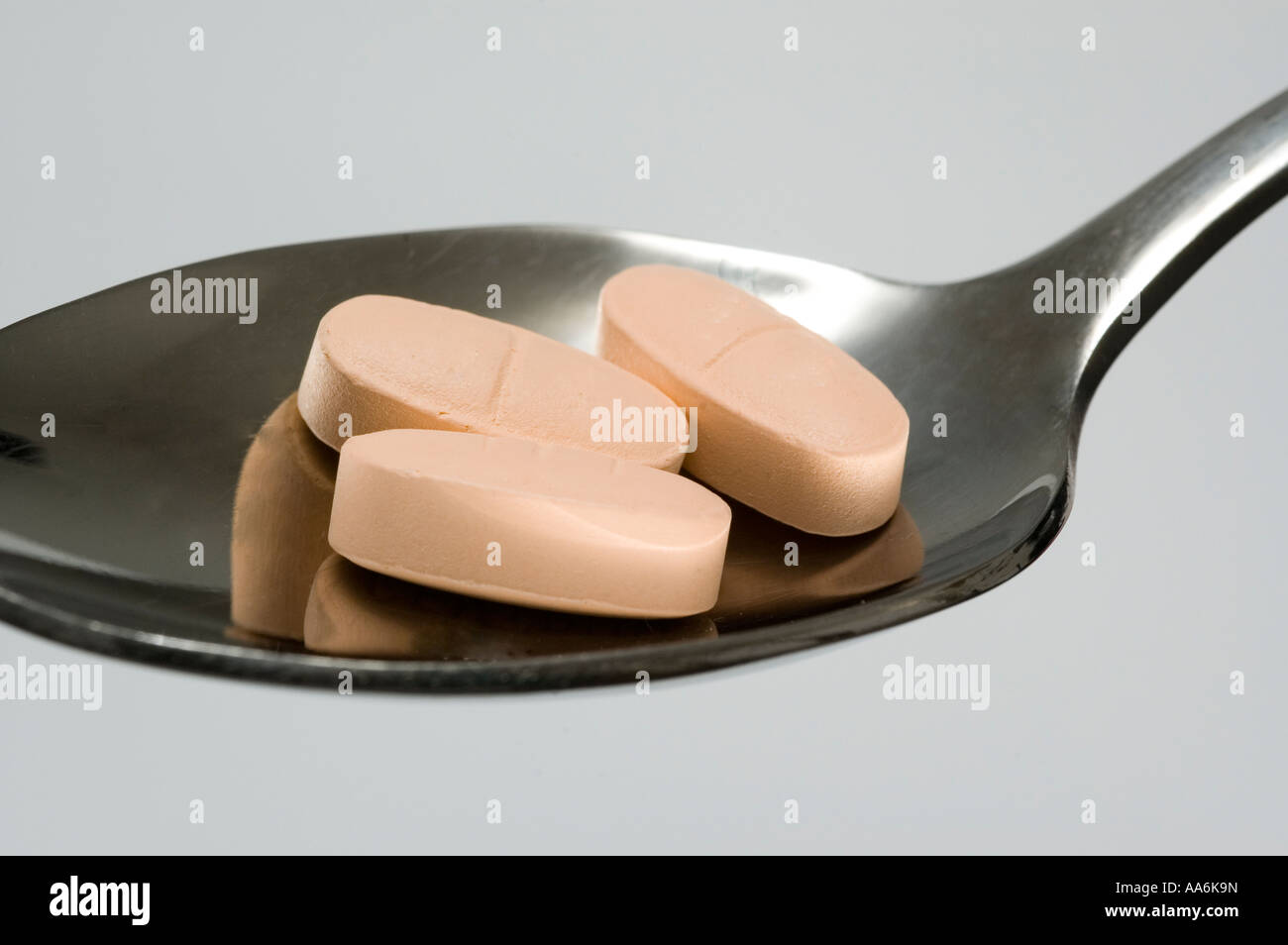 a spoon with tablets Stock Photo - Alamy