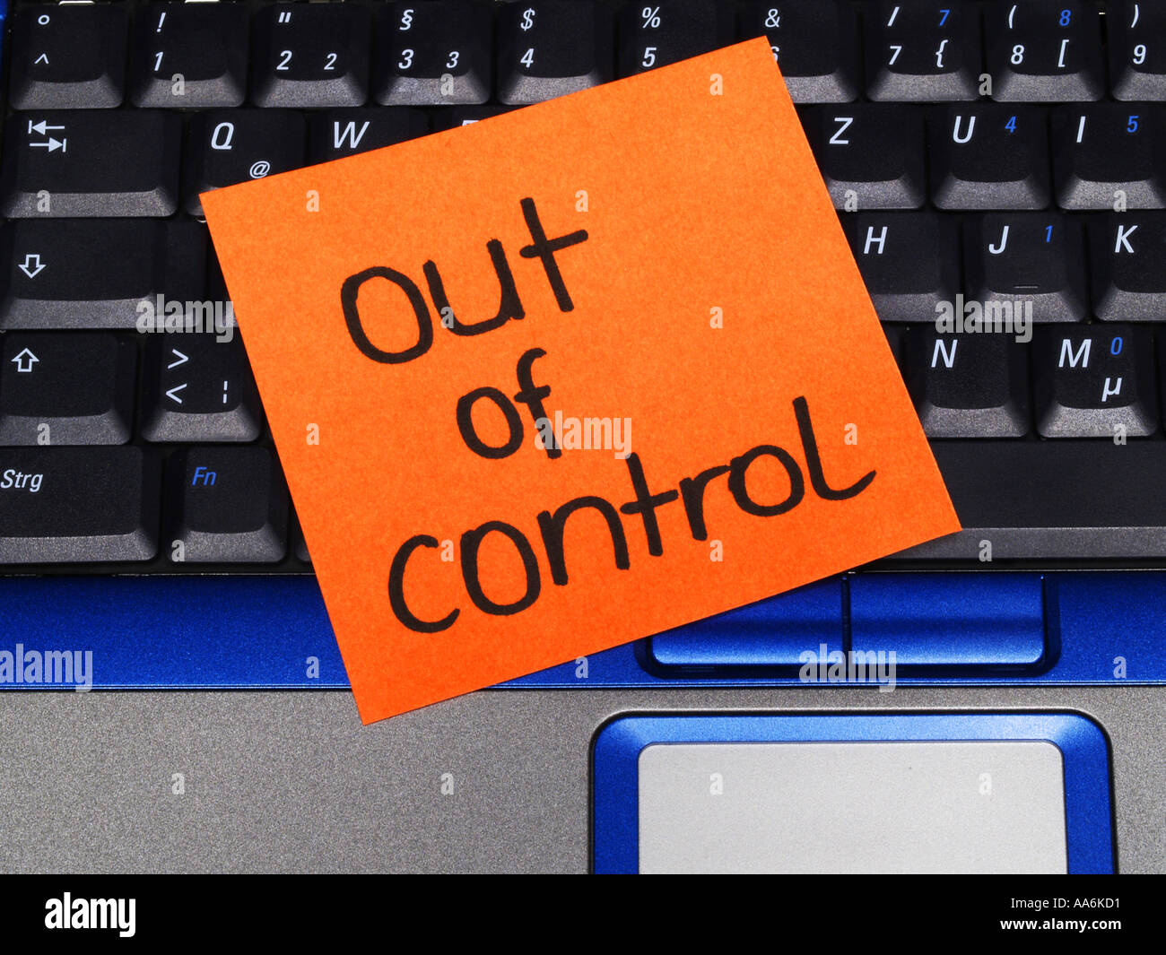 memo note on notebook, out of control Stock Photo - Alamy