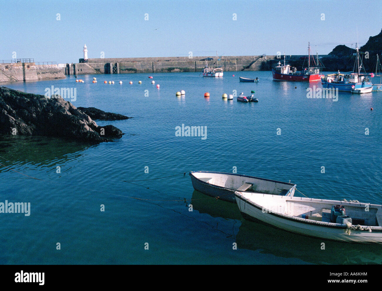 colour photograph of a traditional cornish harbour at high tide with ...