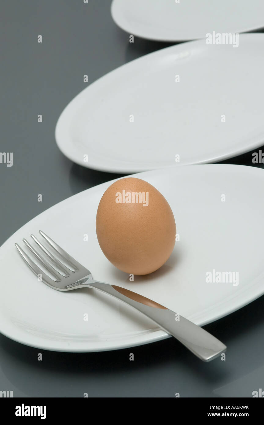 a fork and an egg Stock Photo - Alamy