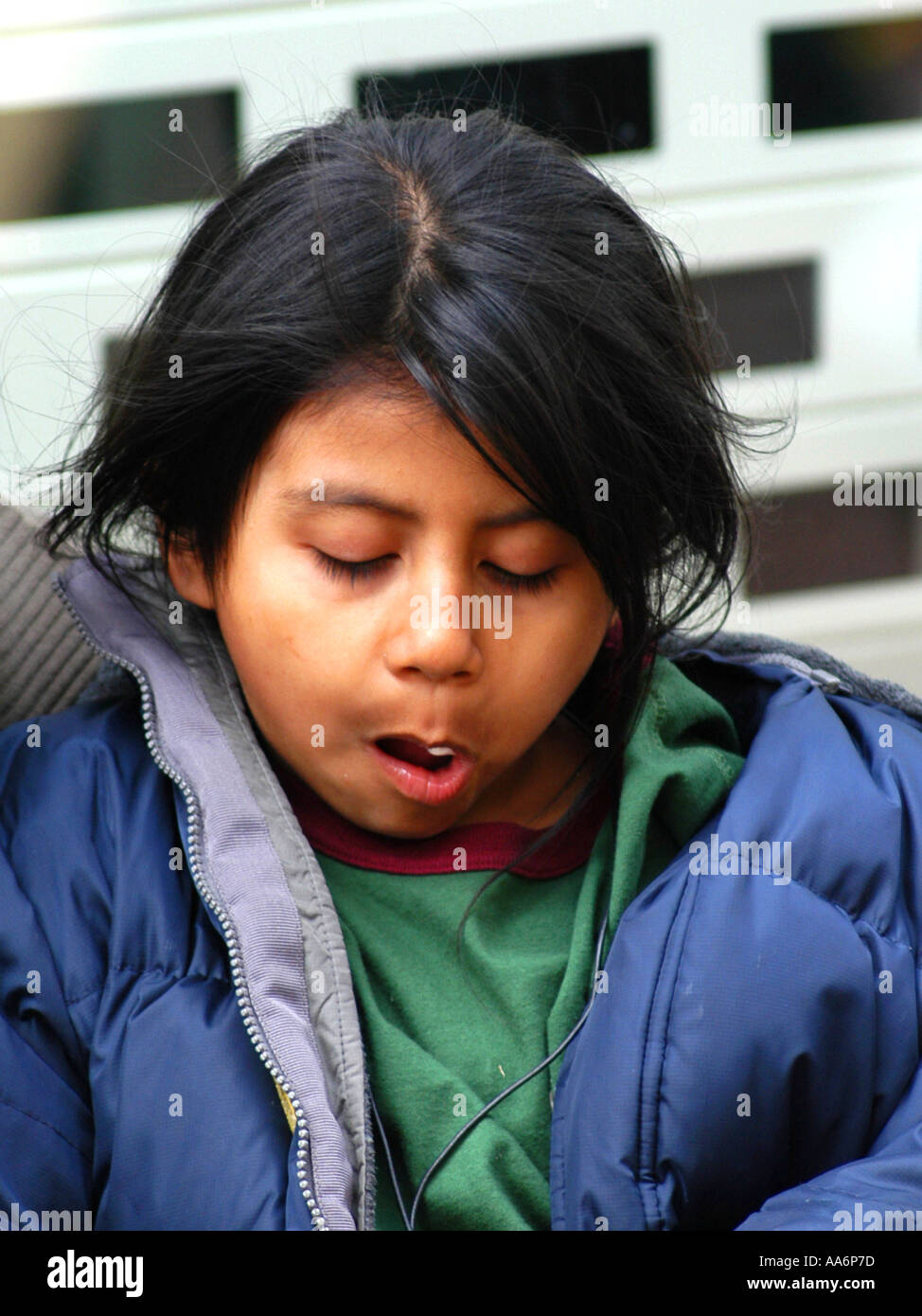 Homeless Mexican boy sitting on the side of the street begging in San ...