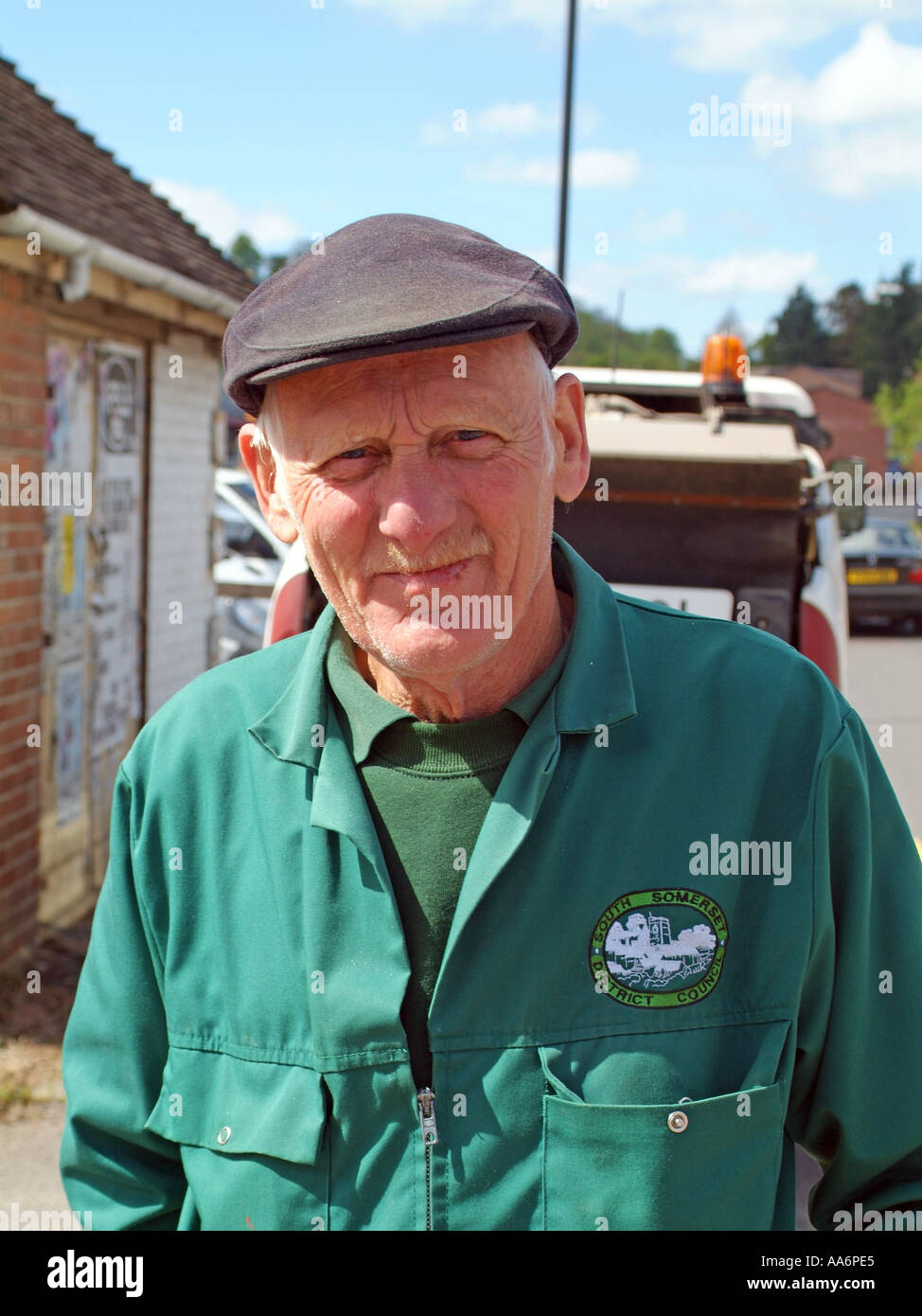 Adult senior male Workman wearing overalls and a flat cap Stock Photo ...